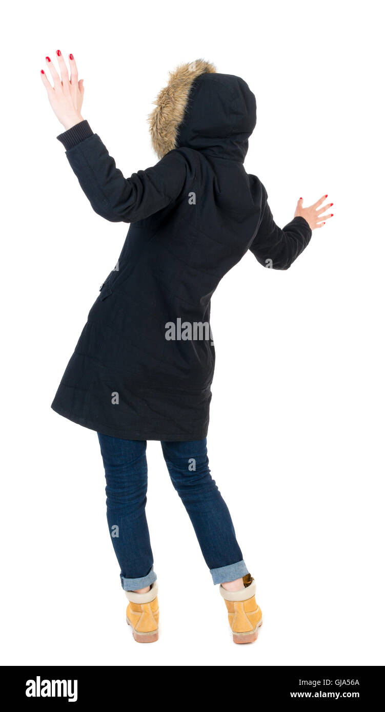 Back view woman in winter jacket Balances waving his arms Stock Photo ...