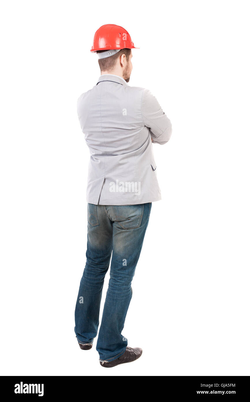 Backview of an engineer in construction helmet stands Stock Photo - Alamy