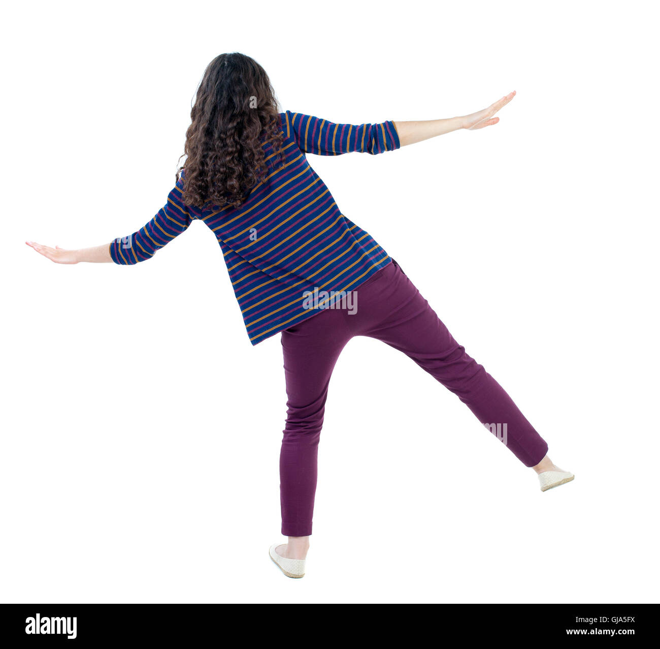 Balancing young woman Stock Photo - Alamy