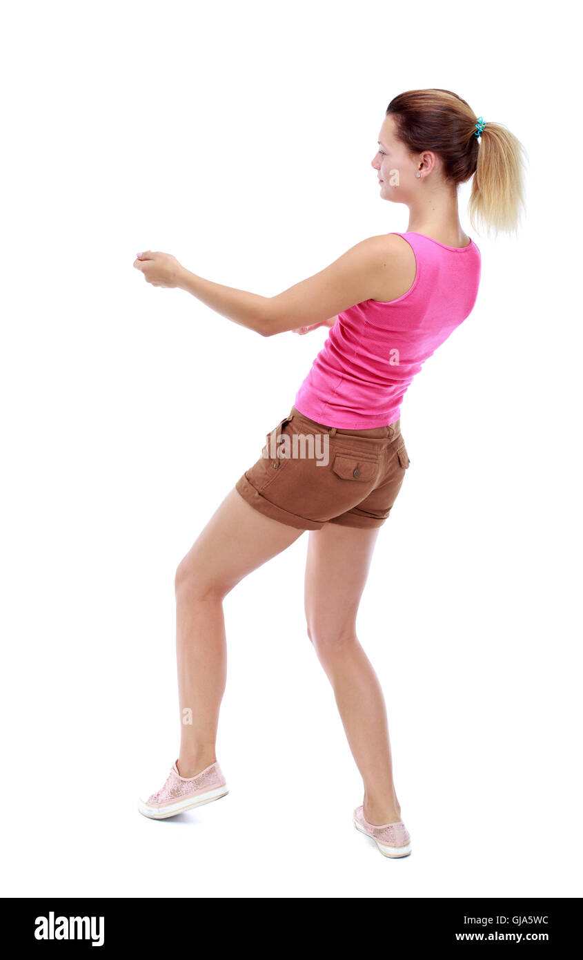 back view of standing girl pulling a rope from the top or cling Stock ...