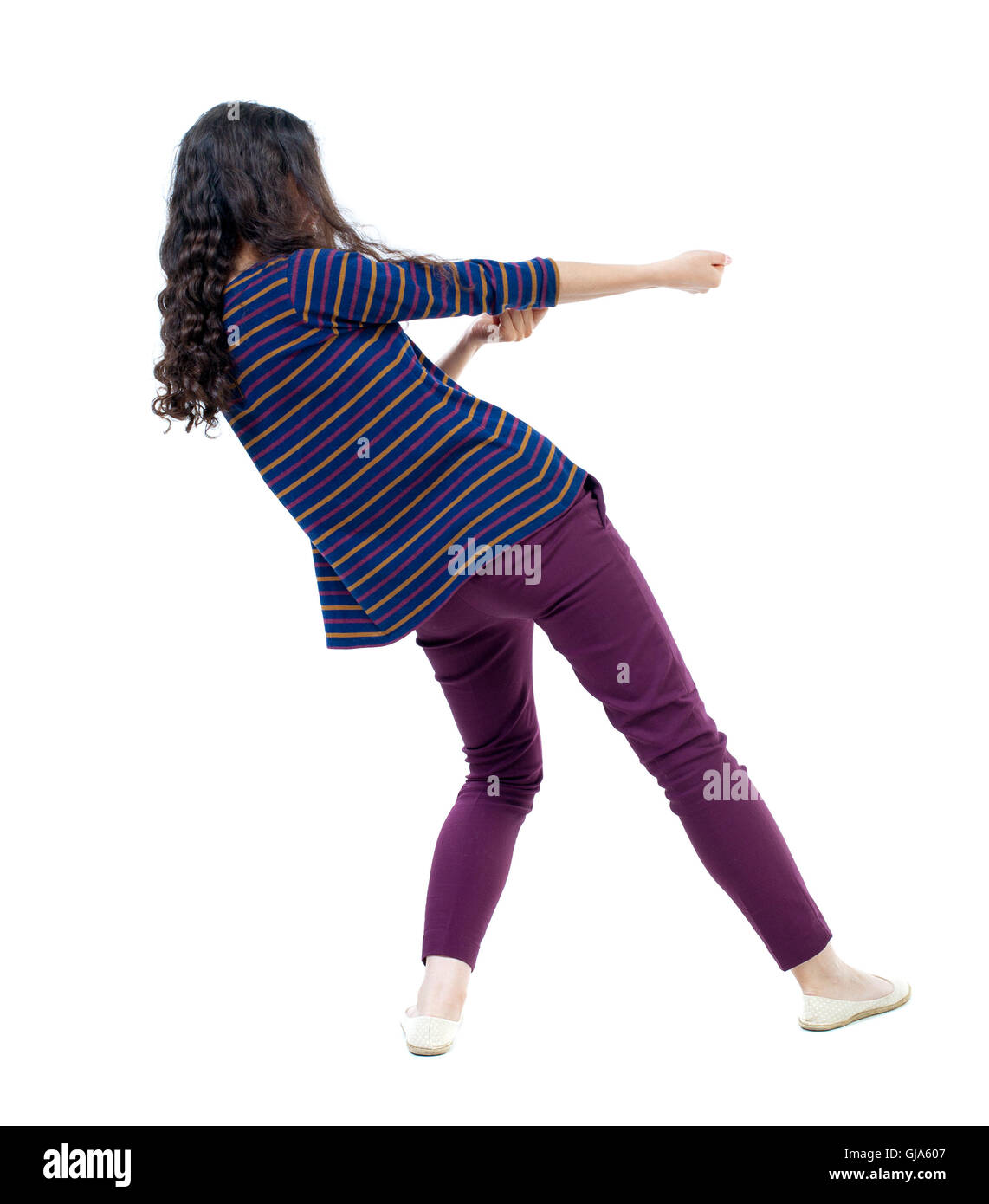 back view of standing girl pulling a rope from top or cling to s Stock ...