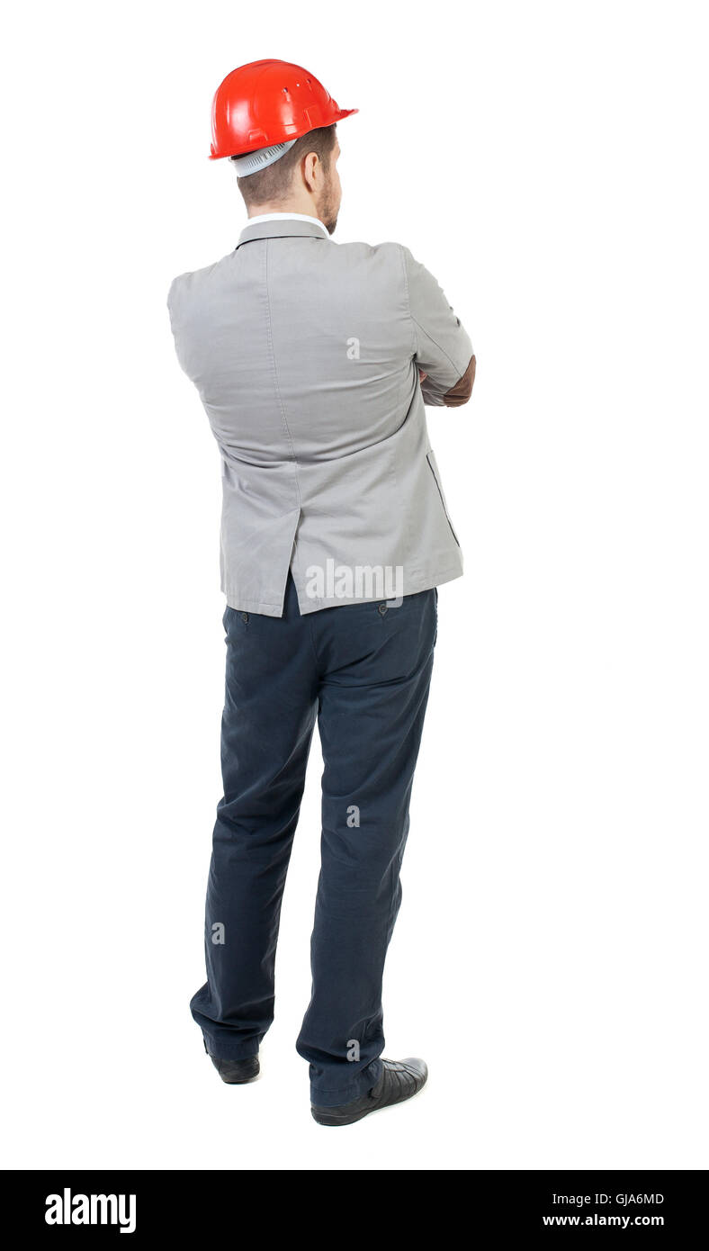 Backview of an engineer in construction helmet stands Stock Photo - Alamy