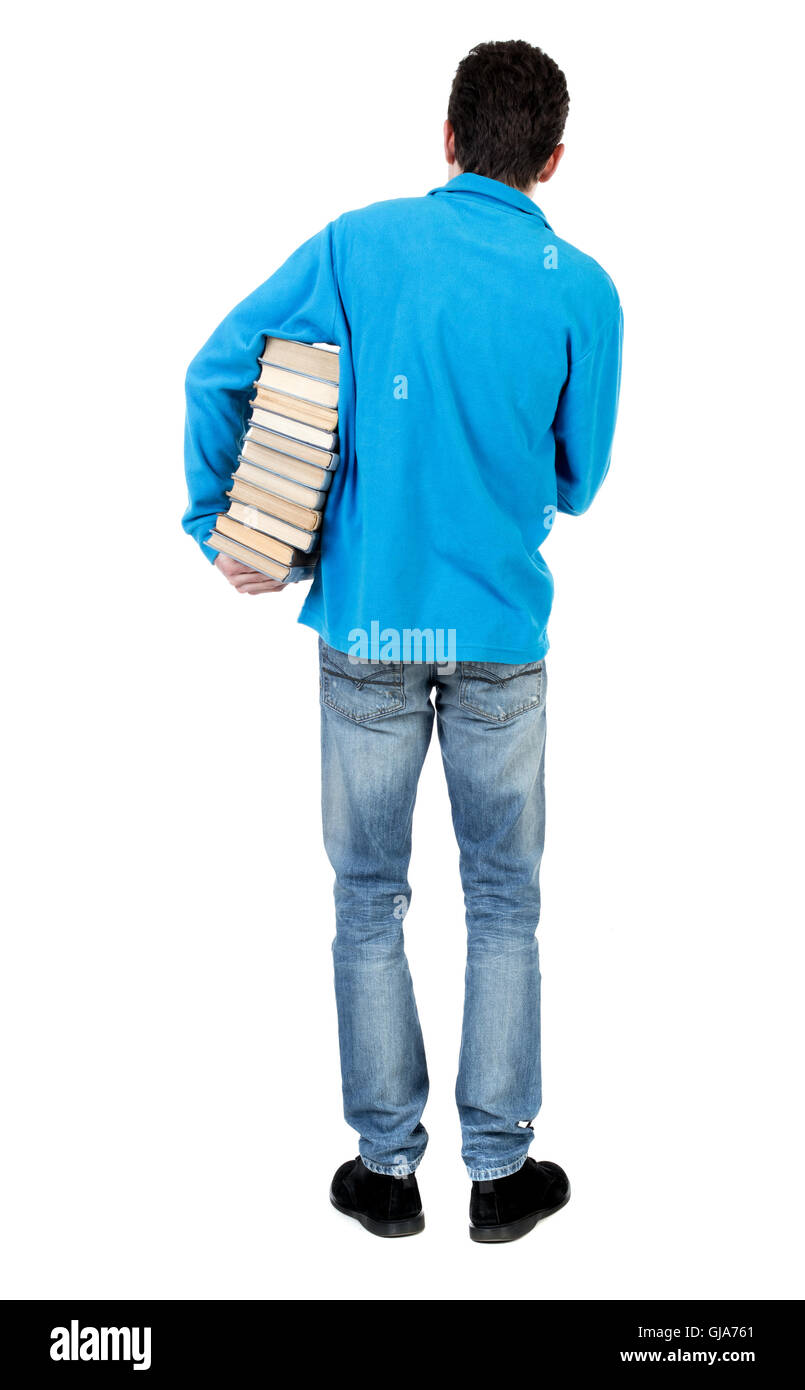 A man carries a heavy pile of books Stock Photo - Alamy