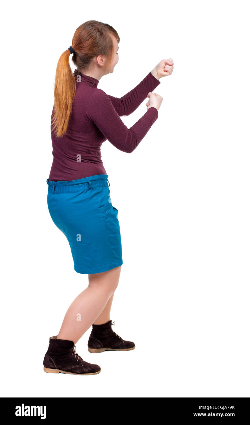 back view of standing girl pulling a rope from the top or cling Stock ...