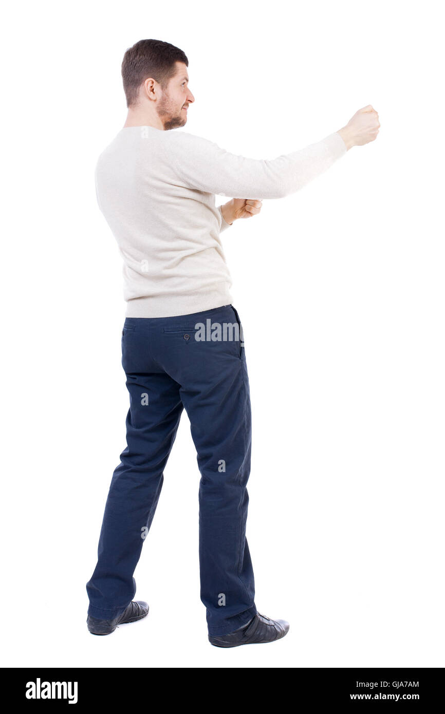 back view of standing man pulling a rope from the top or cling t Stock ...