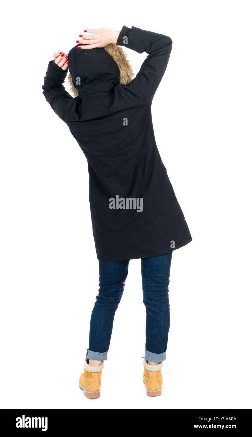 Back view woman in winter jacket Balances waving his arms Stock Photo ...