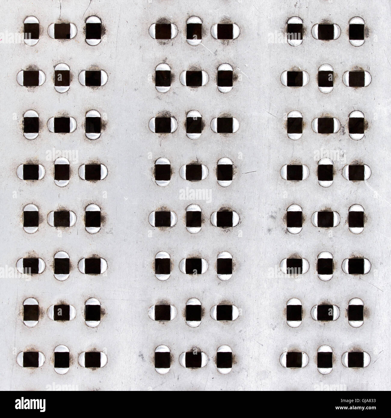 Industrial aluminum metal sheet surface with holes Stock Photo - Alamy