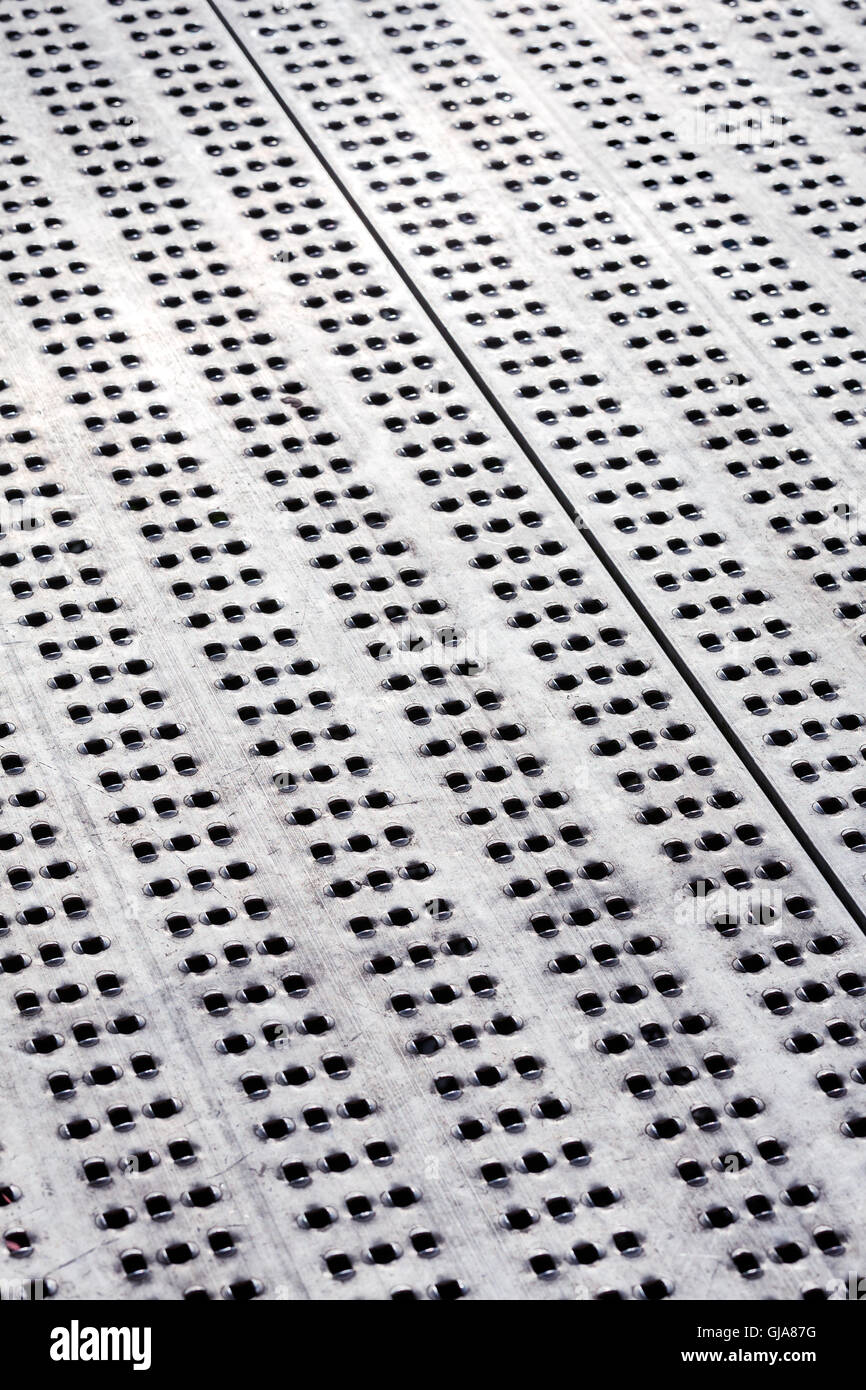 Scratched industrial metal floor surface with holes Stock Photo - Alamy