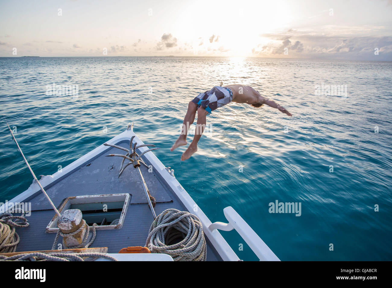 young man is making backflip in the sea Stock Photo - Alamy