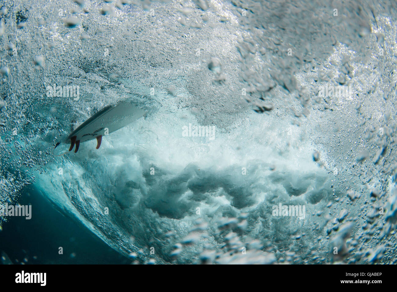 Surfer in wave from below Stock Photo - Alamy