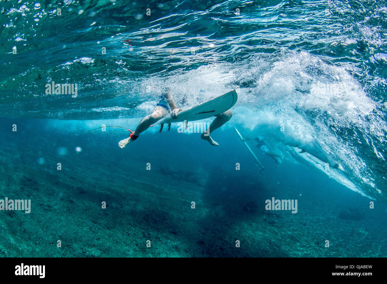 Surfer on surfboard from below Stock Photo - Alamy
