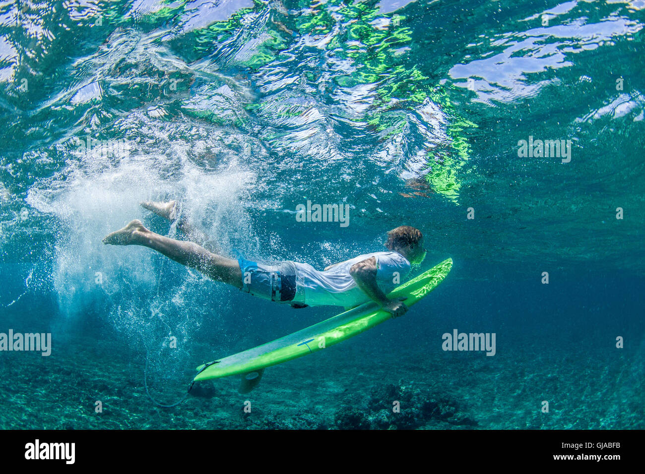 Surfer is diving with surfboard Stock Photo - Alamy