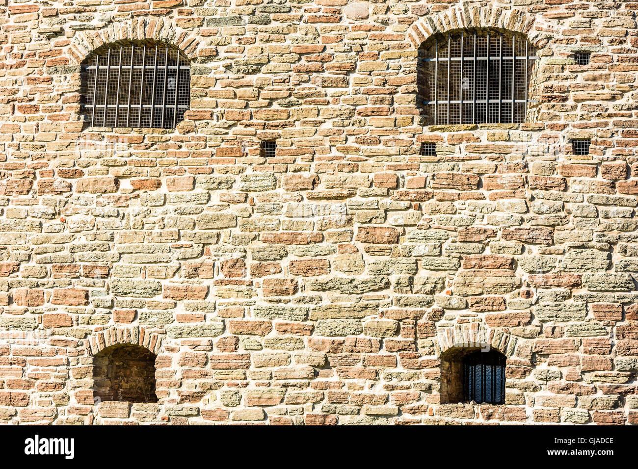 Barred prison windows on a castle or fortification Stock Photo - Alamy