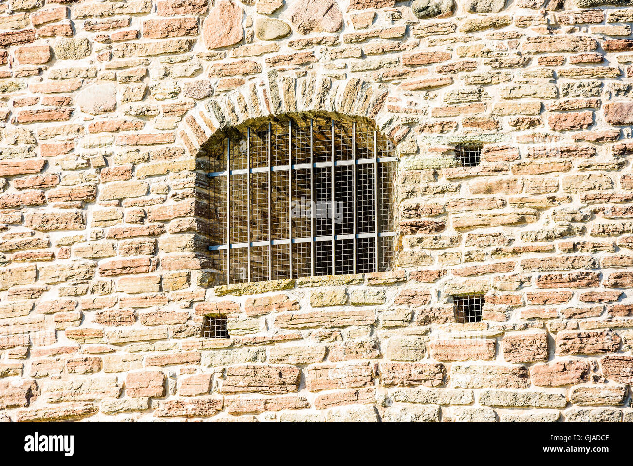 Barred prison windows on a castle or fortification Stock Photo - Alamy