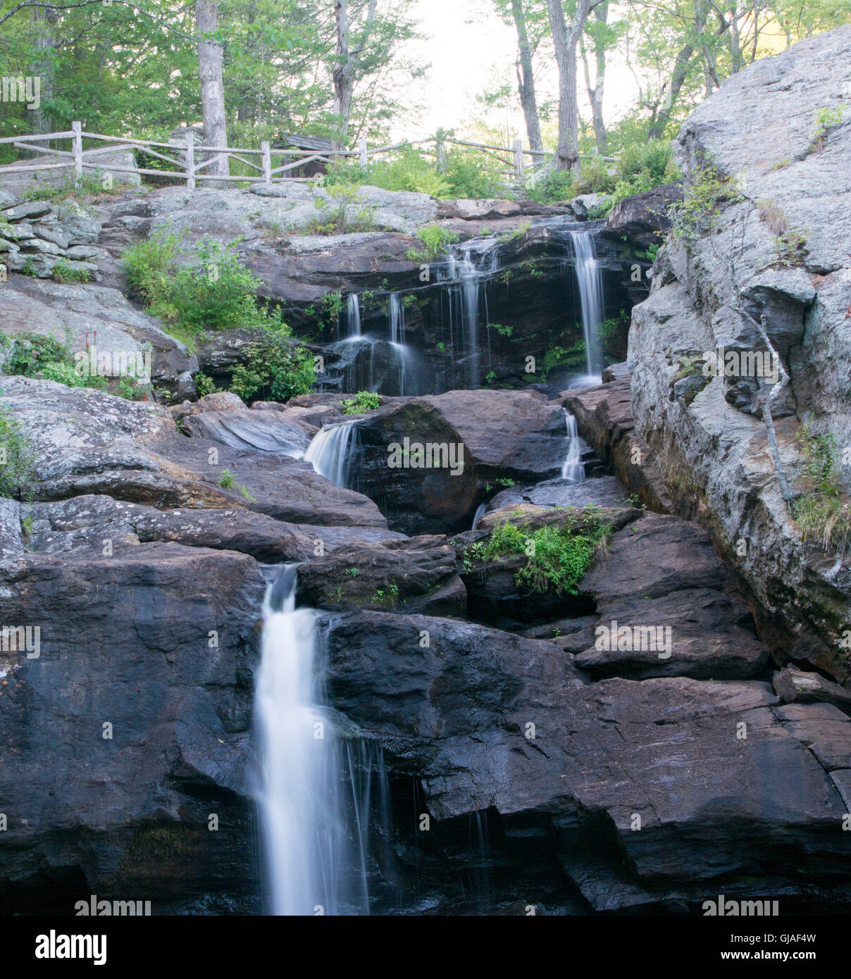 Waterfall flowing over rocky cliff Stock Photo - Alamy