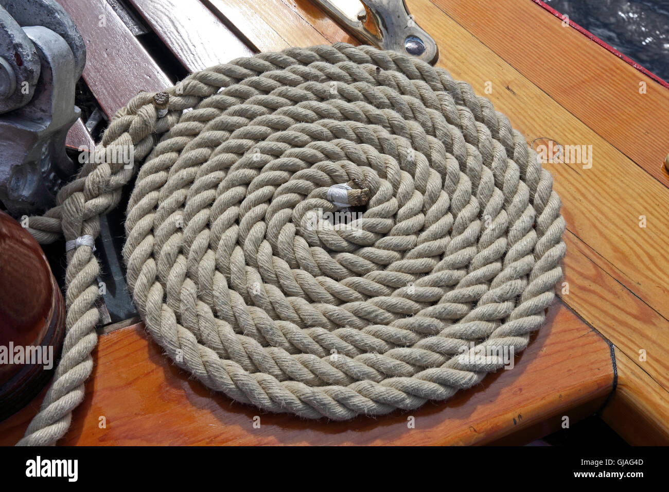 Rope coiled on deck of yacht Stock Photo - Alamy