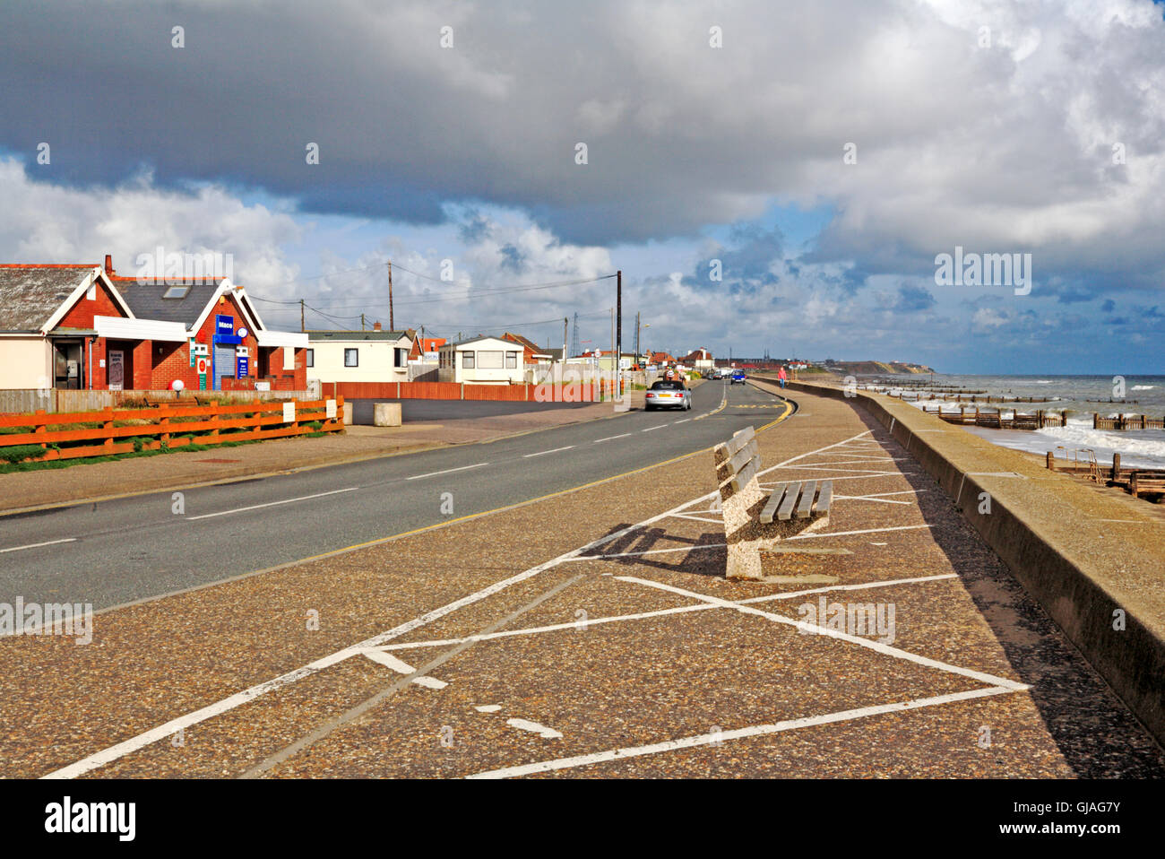 A view of the coast road and seafront at Walcott, Norfolk, England ...