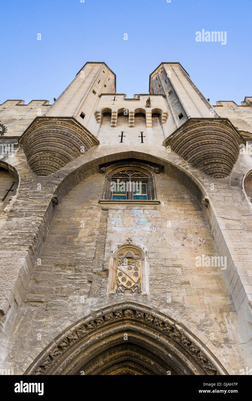 Looking up at the imposing Gothic twin towered facade of the Palais ...