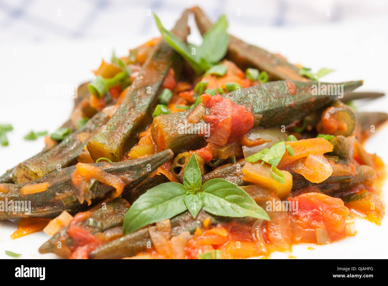 Okra dish stewed with tomatoes, carrot and onion closeup (Traditional ...