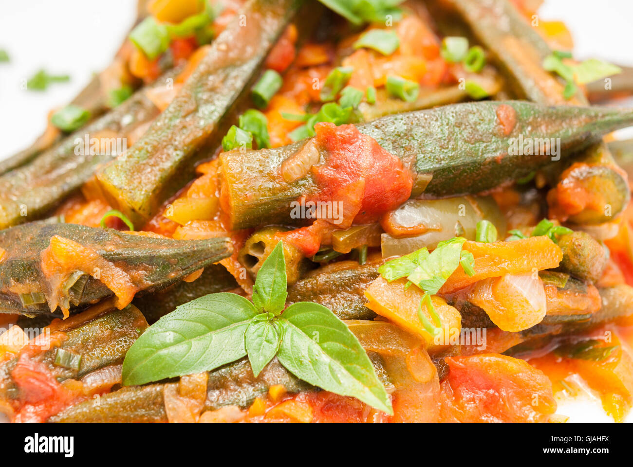 Okra dish stewed with tomatoes, carrot and onion closeup (Traditional ...