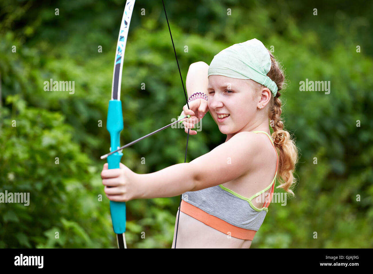 Girl archer with bow and arrow outdoors Stock Photo - Alamy