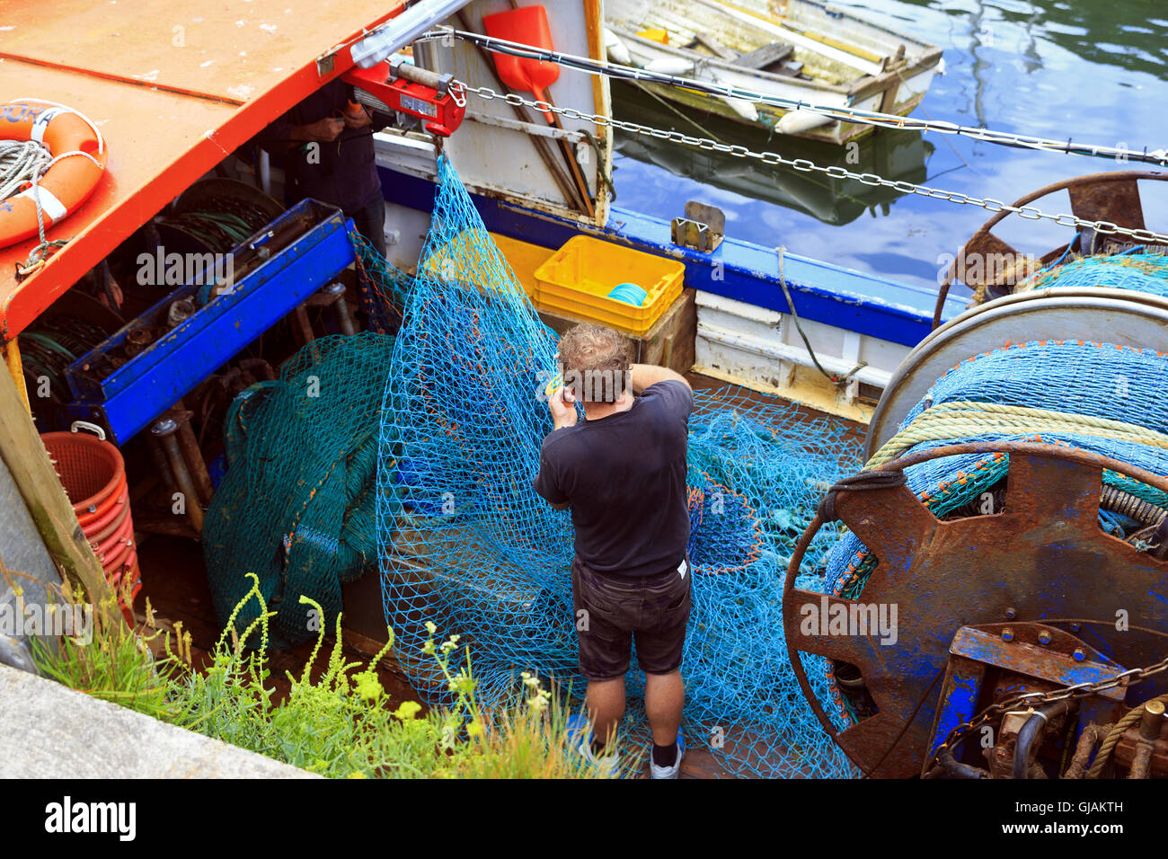 Repairing the Fishing Nets Stock Photo - Alamy