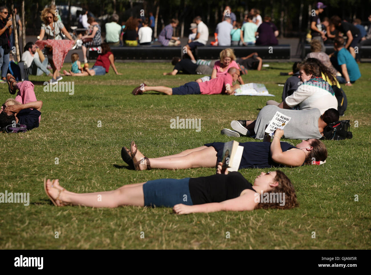 People relaxing outside the Tate Modern during a spell of hot weather ...