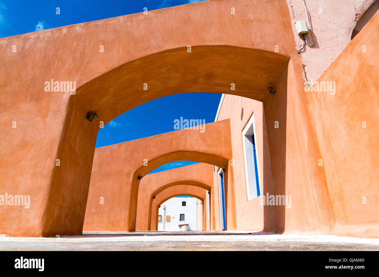 Gallery. Orange arches and blue sky Stock Photo - Alamy