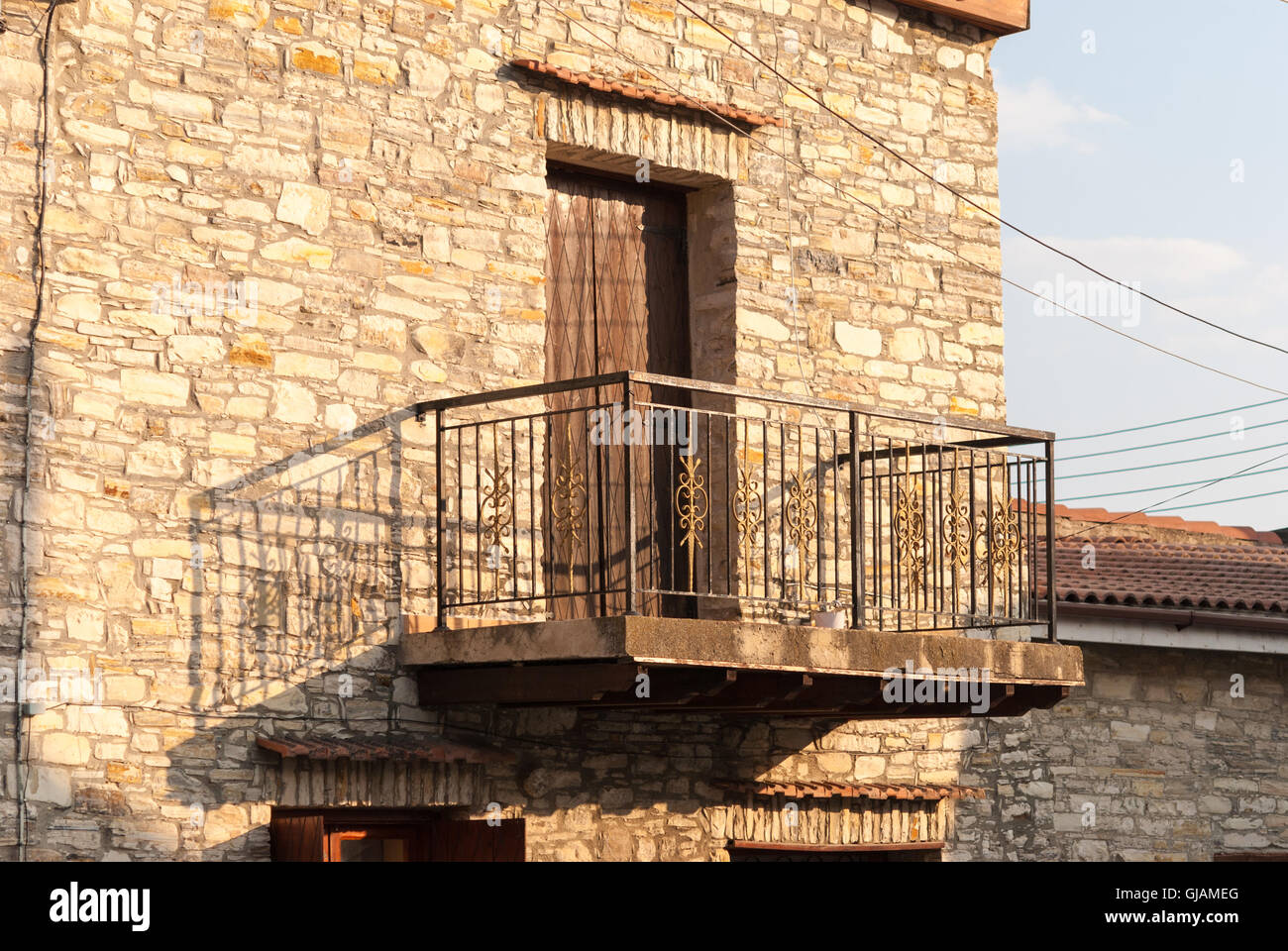 Old balcony with the rustic wooden door on the facade of traditional ...