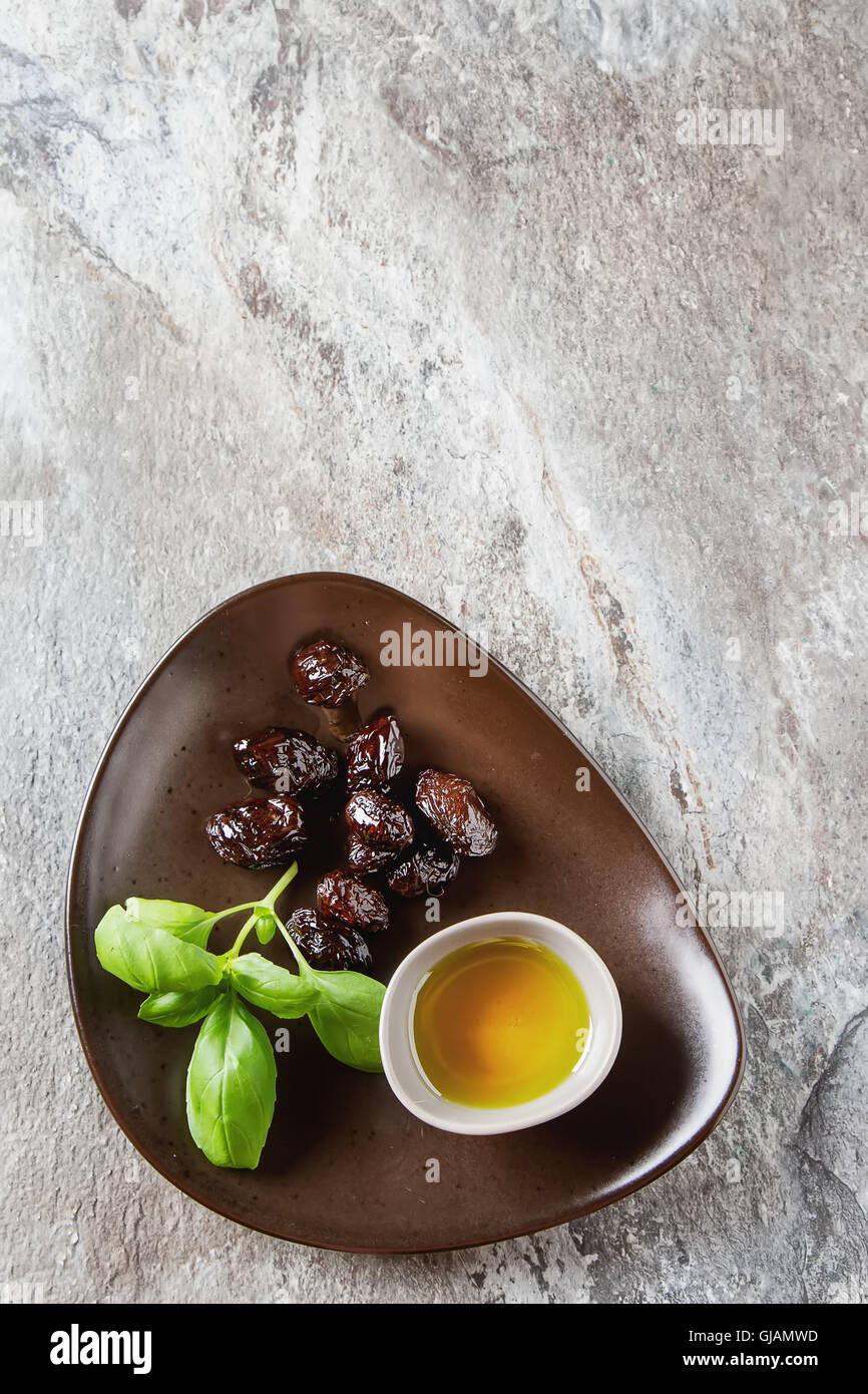 Green ripe olives and olive oil in a bowl. Dark background Stock Photo ...