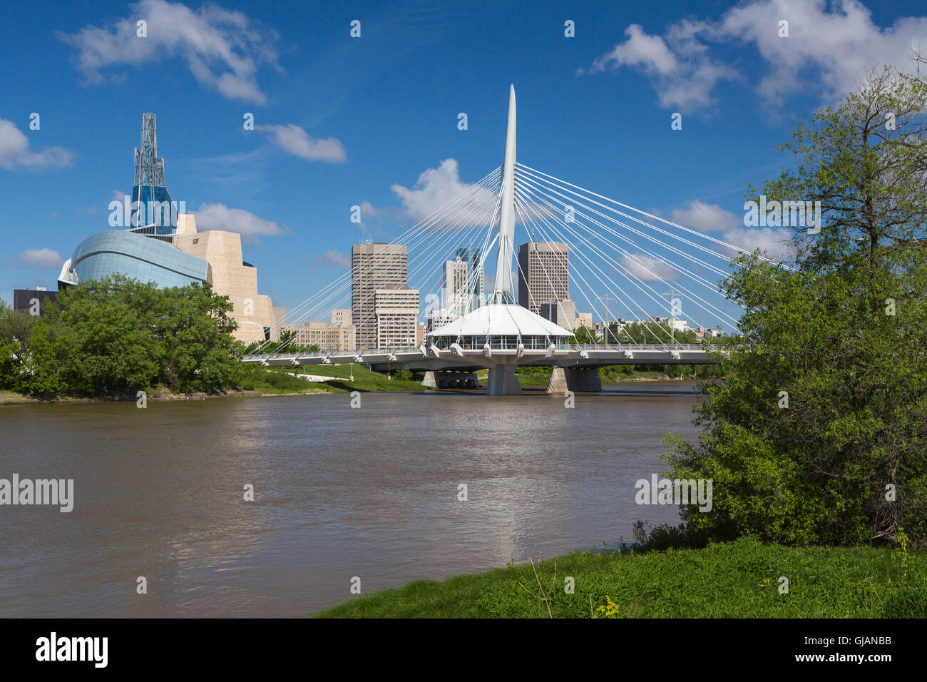 The Red River, Provencher Bridge and the city skyline of Winnipeg ...