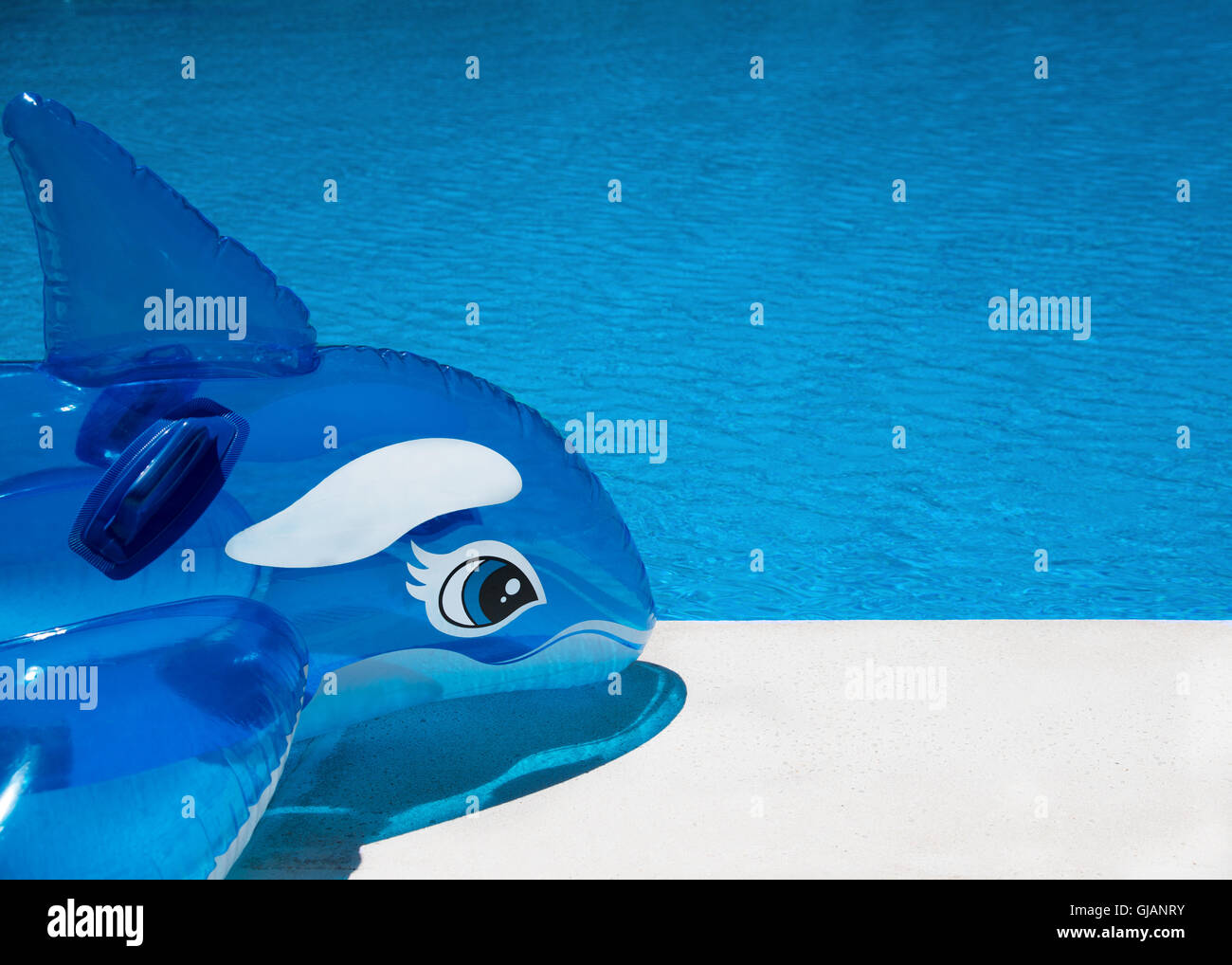Pool side background shot on a sunny summers day showing an inflatable ...