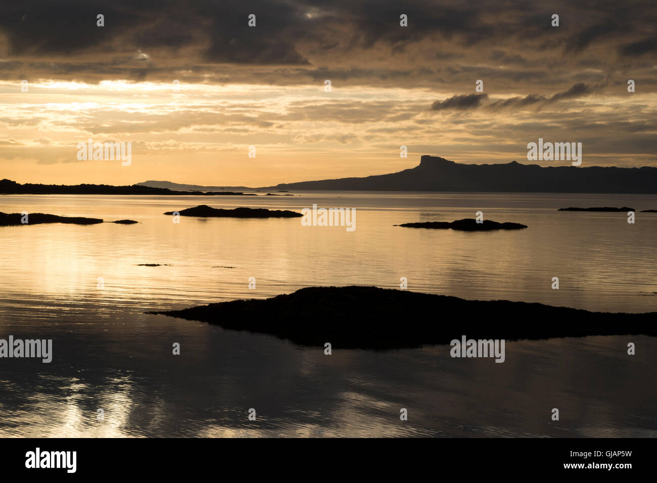 Sunset over the Hebridean island of Eigg from the Arisaig coastline on ...