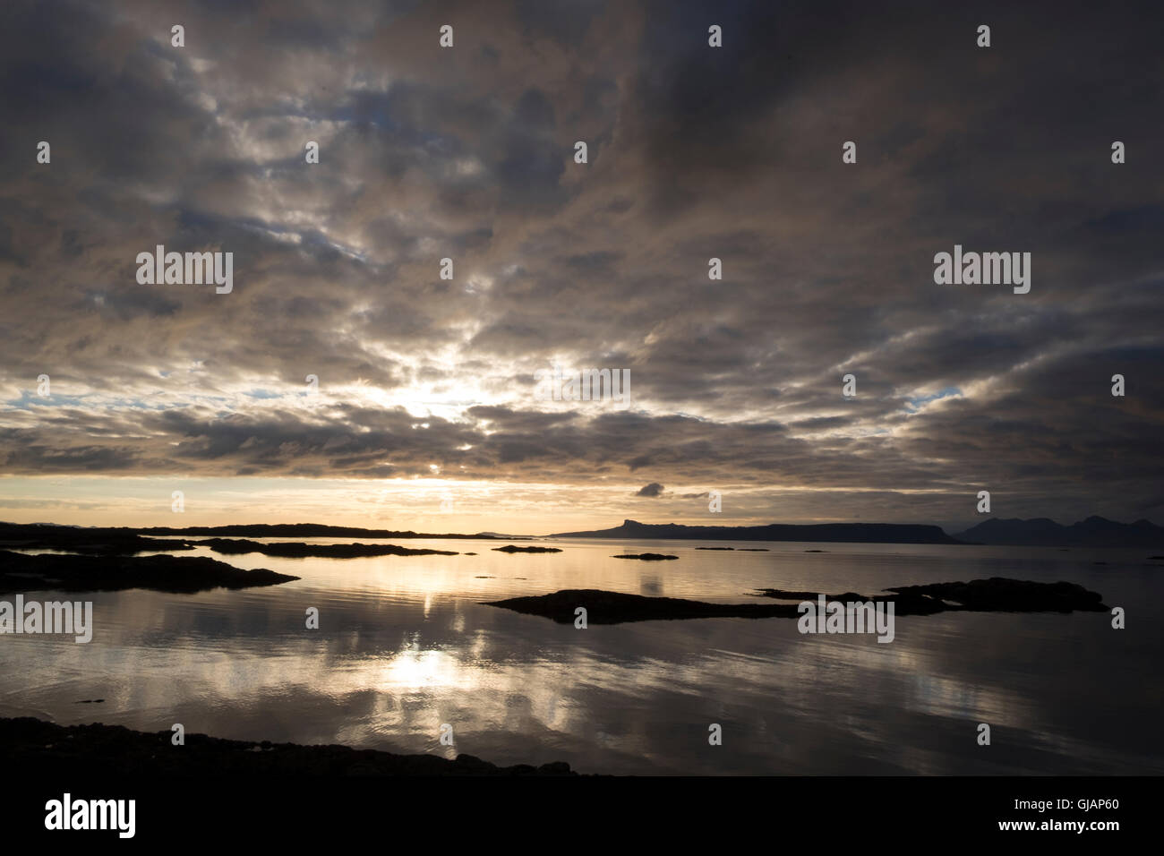 Sunset over the Hebridean island of Eigg from the Arisaig coastline on ...