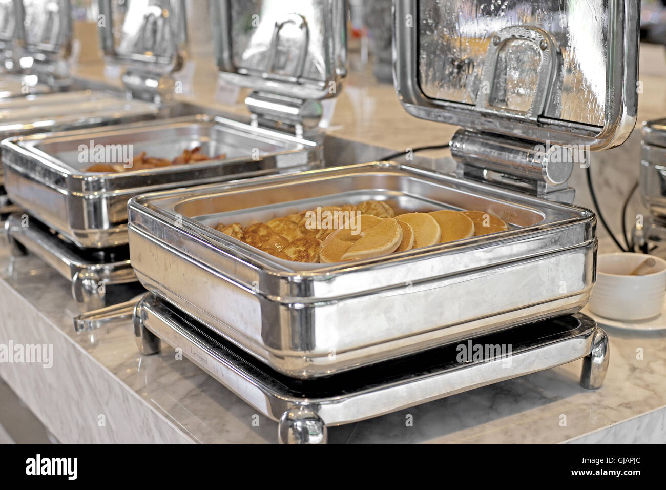 row of food service steam pans on buffet table Stock Photo - Alamy