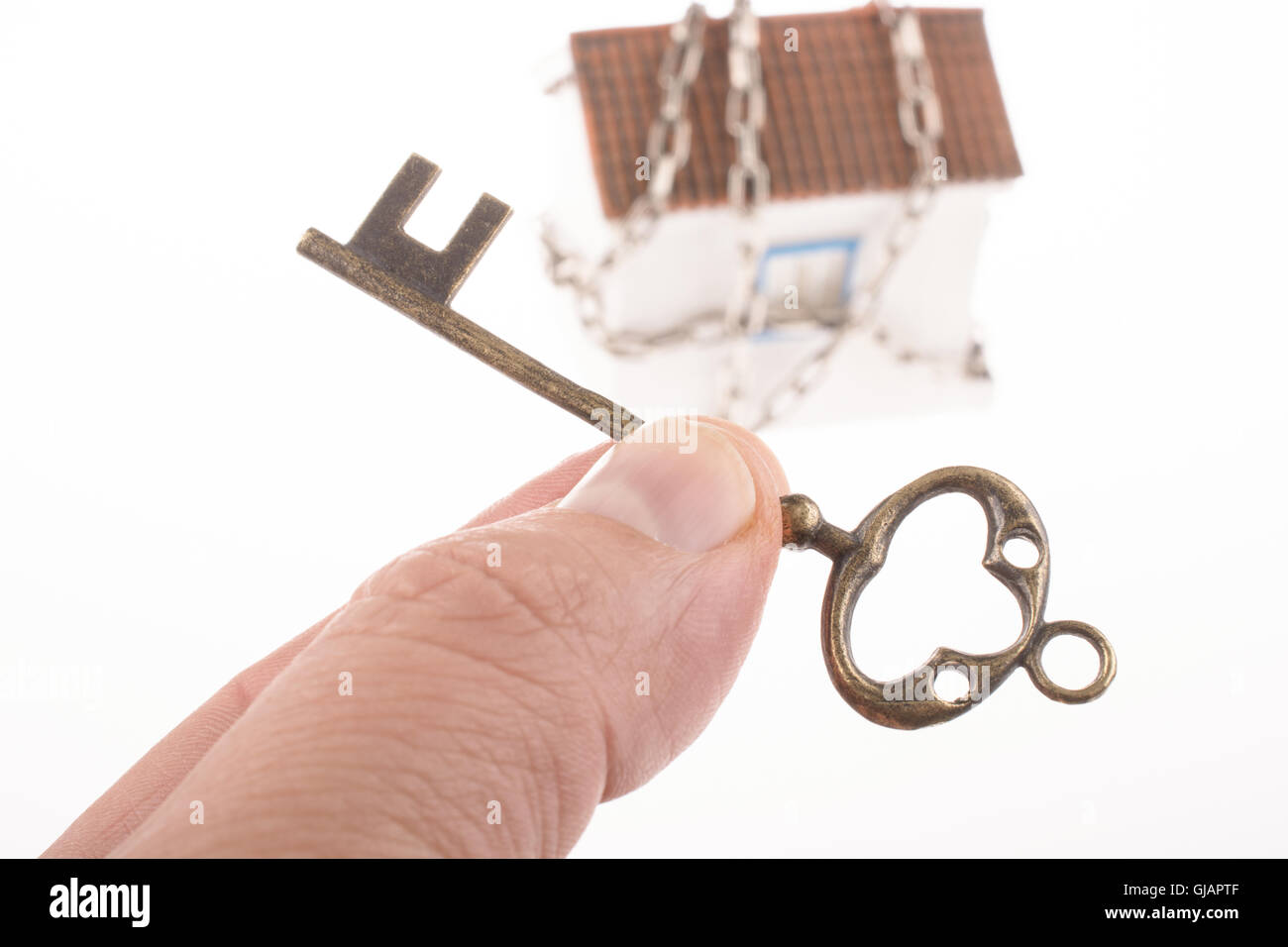 key and a house in chains on a white background Stock Photo - Alamy
