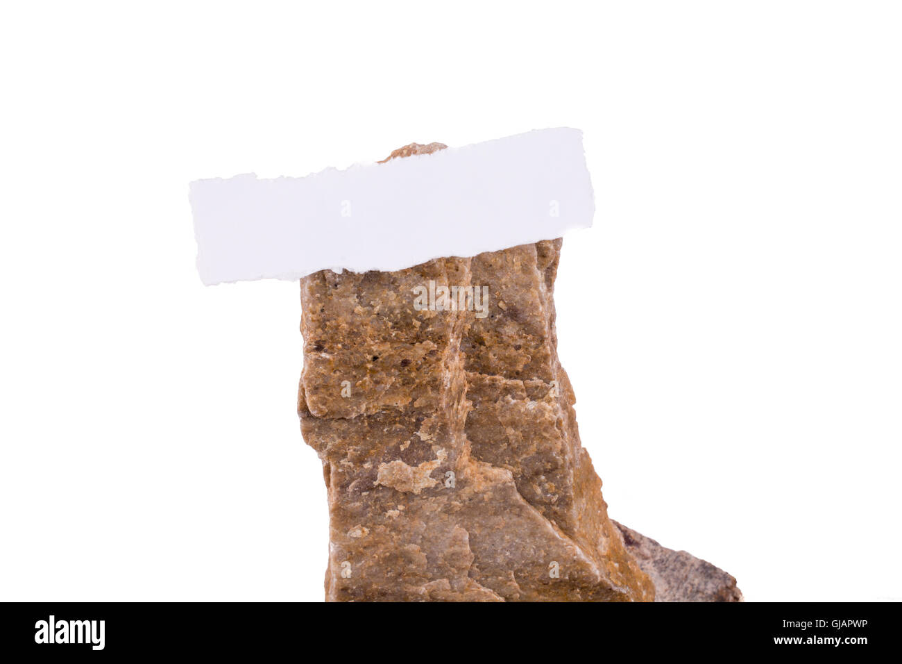 Torn paper on top of the rock Stock Photo - Alamy