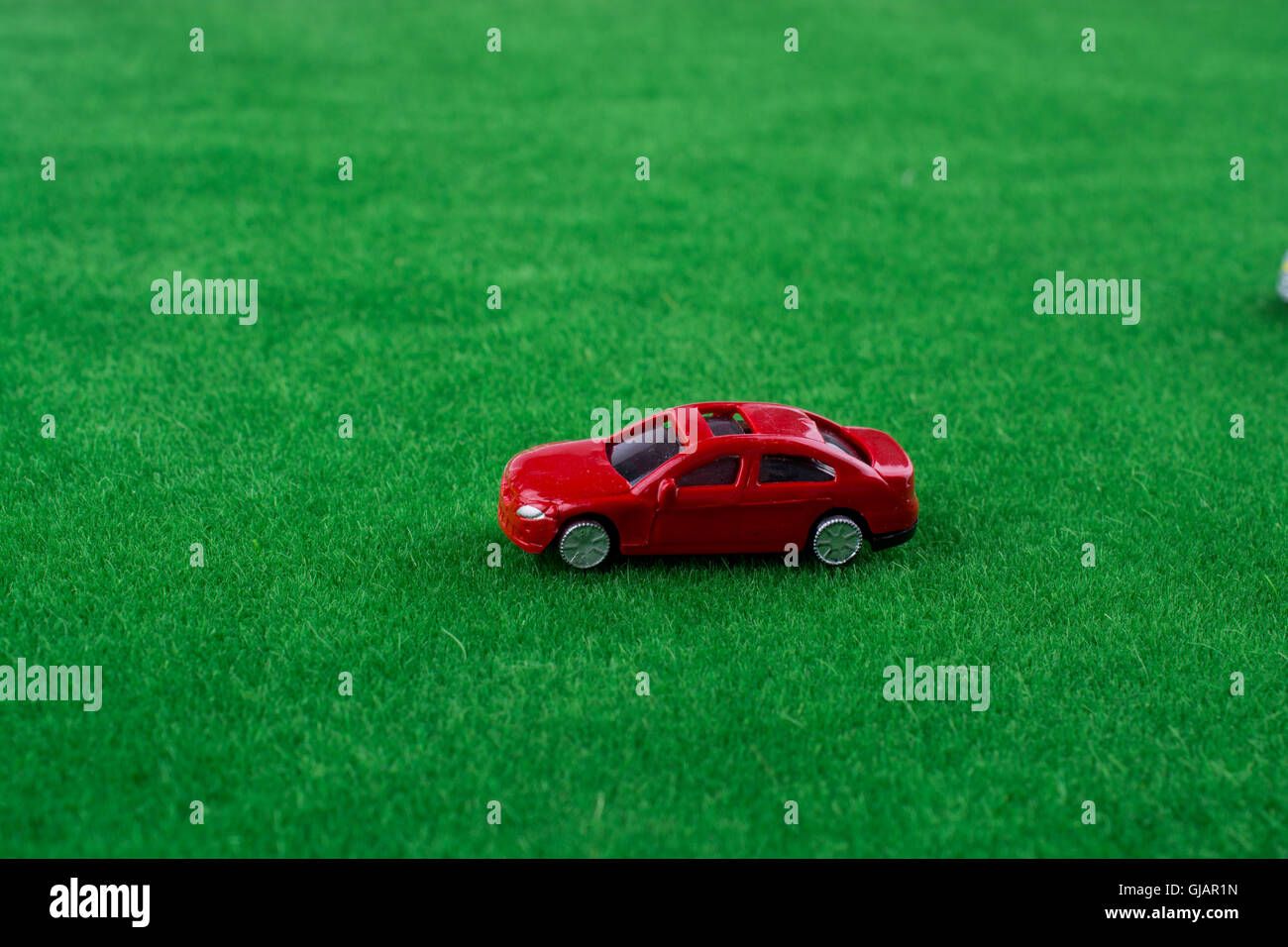 Color cars on green grass Stock Photo - Alamy