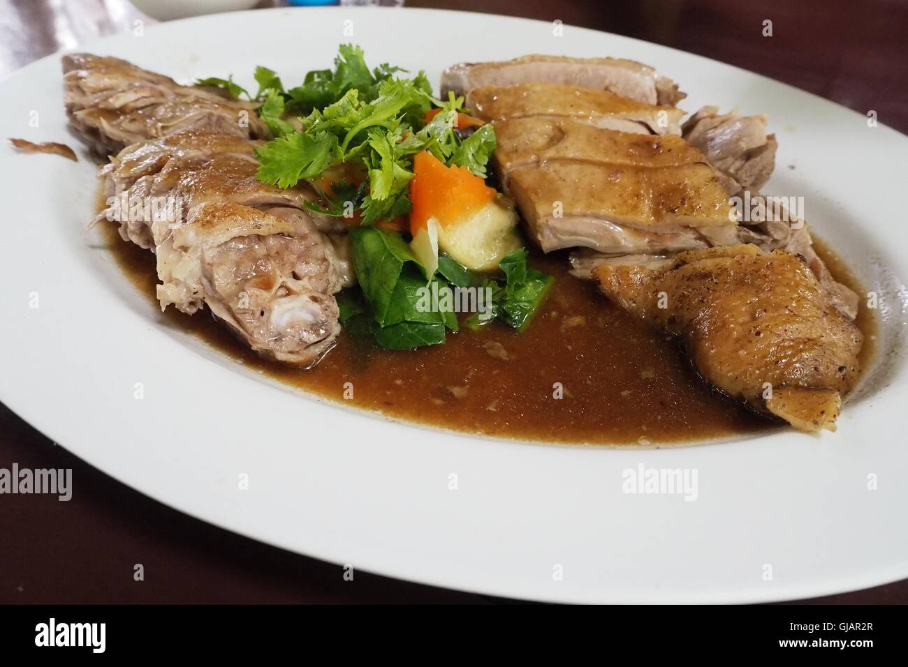 Steam duck on white plate Stock Photo - Alamy