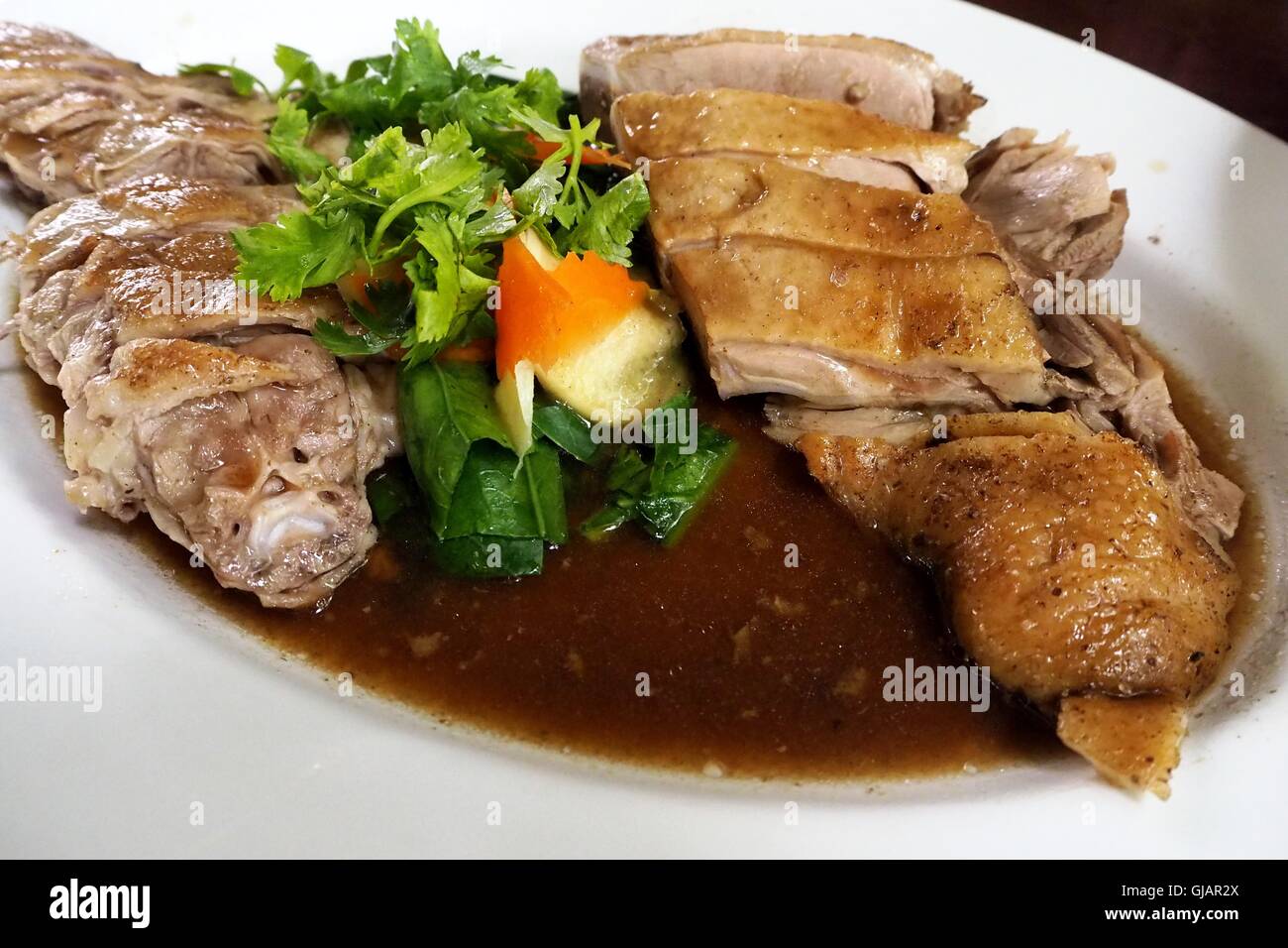 Steam duck on white plate Stock Photo - Alamy