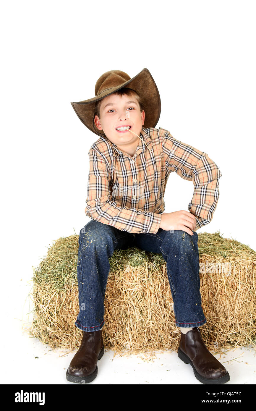 Boy chewing on a piece of straw Stock Photo - Alamy