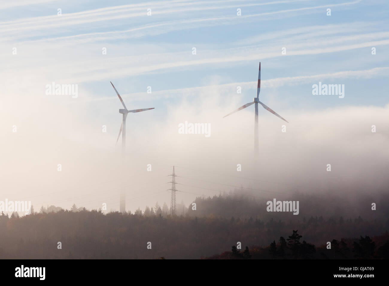 Wind turbines in fog Stock Photo - Alamy