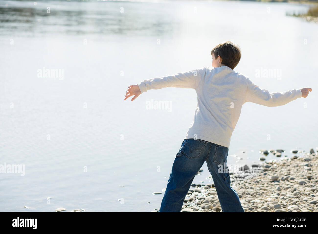 Boy Throwing Stones Stock Photo - Alamy