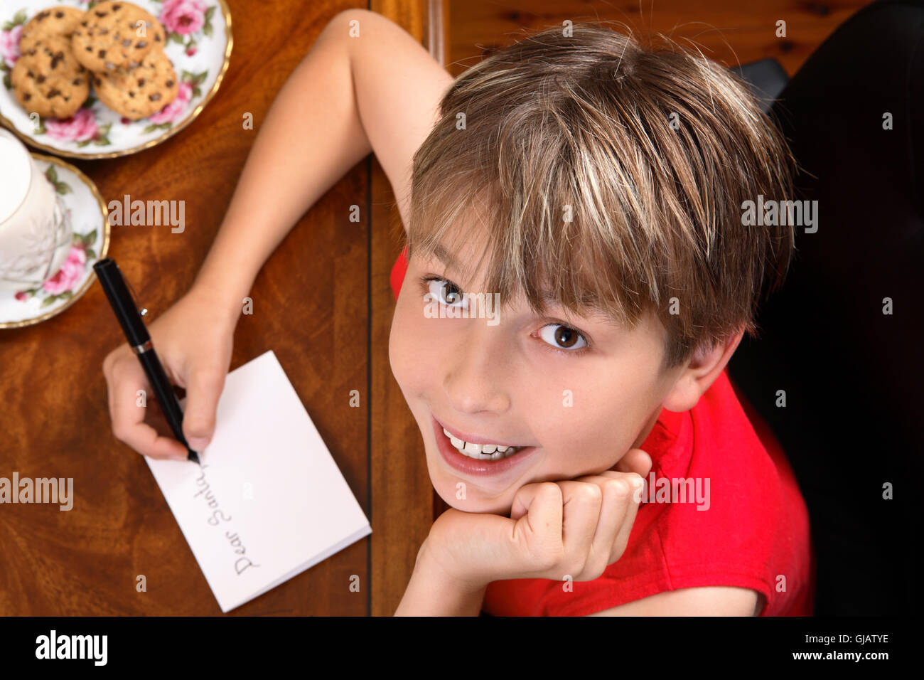 Child writing a letter or card at Christmas Stock Photo - Alamy