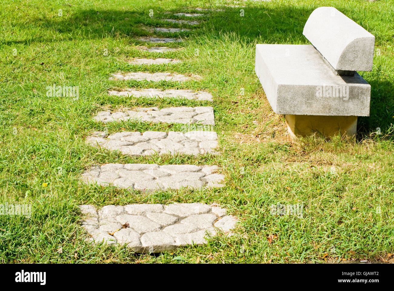 Stone walkway and stone bench Stock Photo - Alamy