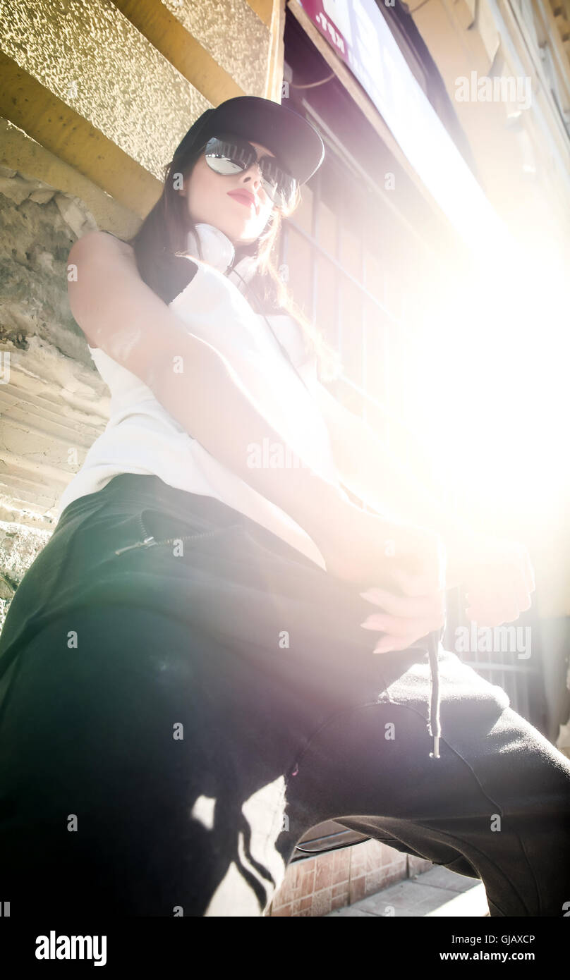 A beautiful young Hip Hop Rapper girl with Headphones in a urban ...
