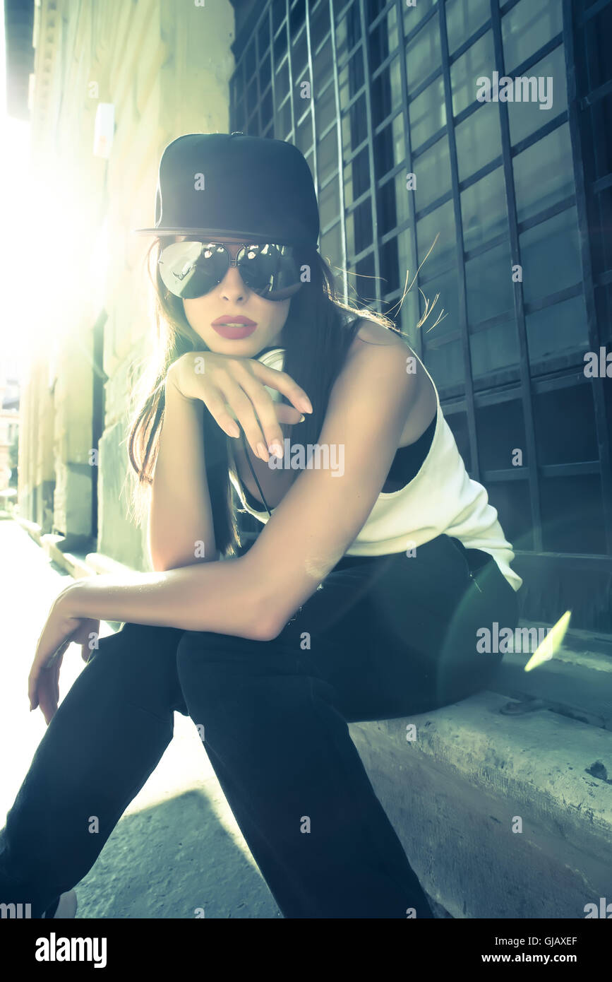 A beautiful young Hip Hop Rapper girl with Headphones in a urban ...