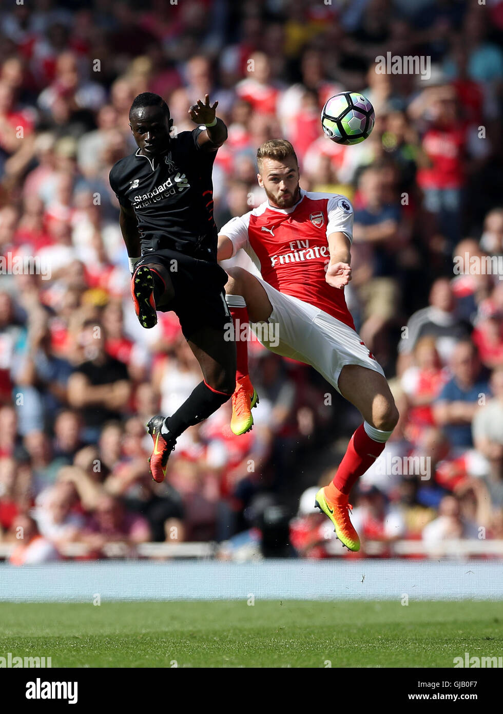 Liverpool's Sadio Mane (left) and Arsenal's Calum Chambers battle for ...