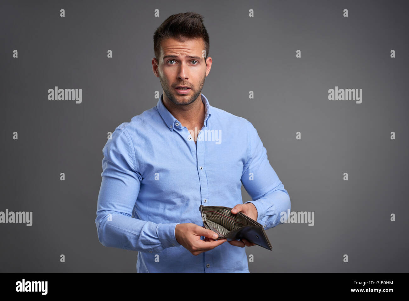 A poor handsome young man feeling stressed looking in to the camera and ...
