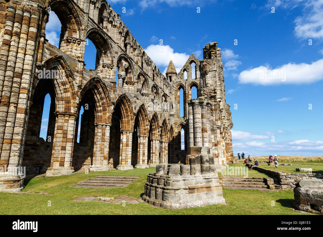 Tourists visiting the ruins of Whitby Abbey. In Whitby, North Yorkshire ...